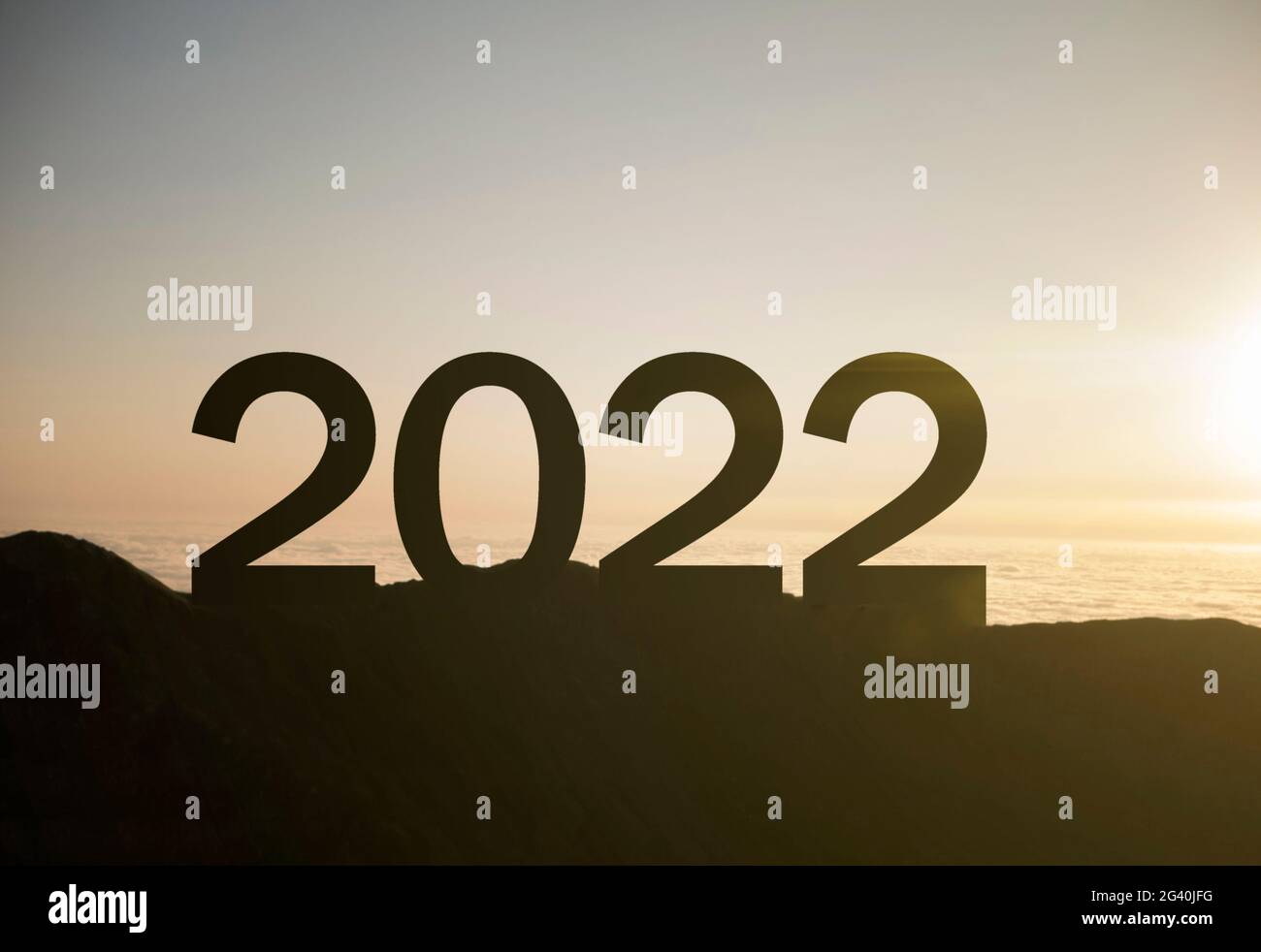 2022 happy new year sign on top of the mountain with sunset, symbol of ...
