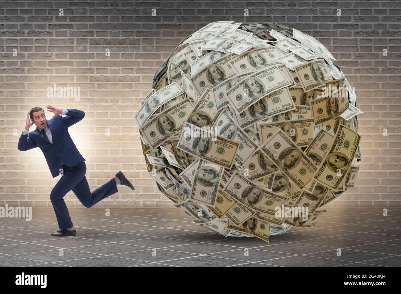 Businessman running away from dollar ball Stock Photo - Alamy