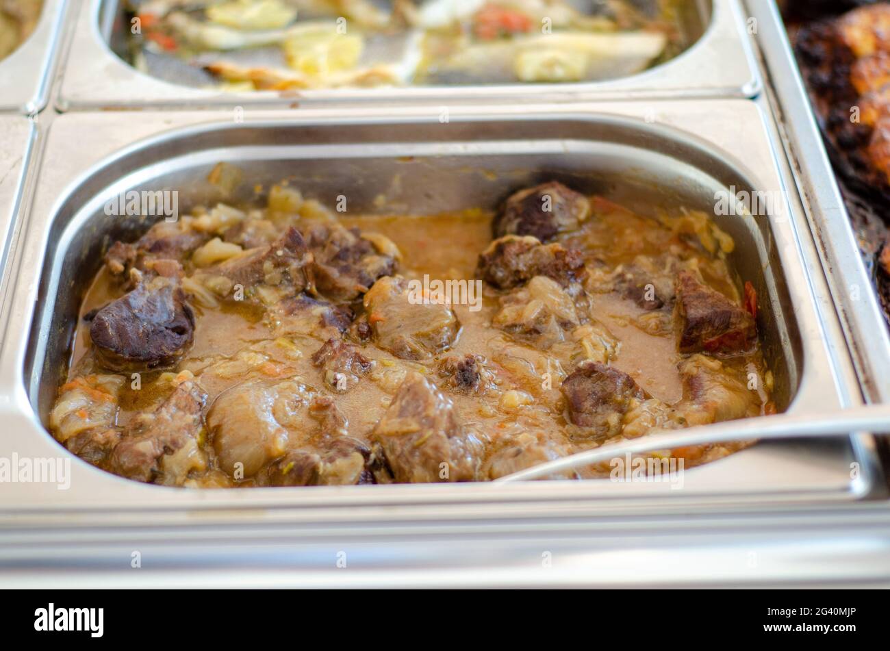 Serving of stewed meat in a buffet Stock Photo - Alamy