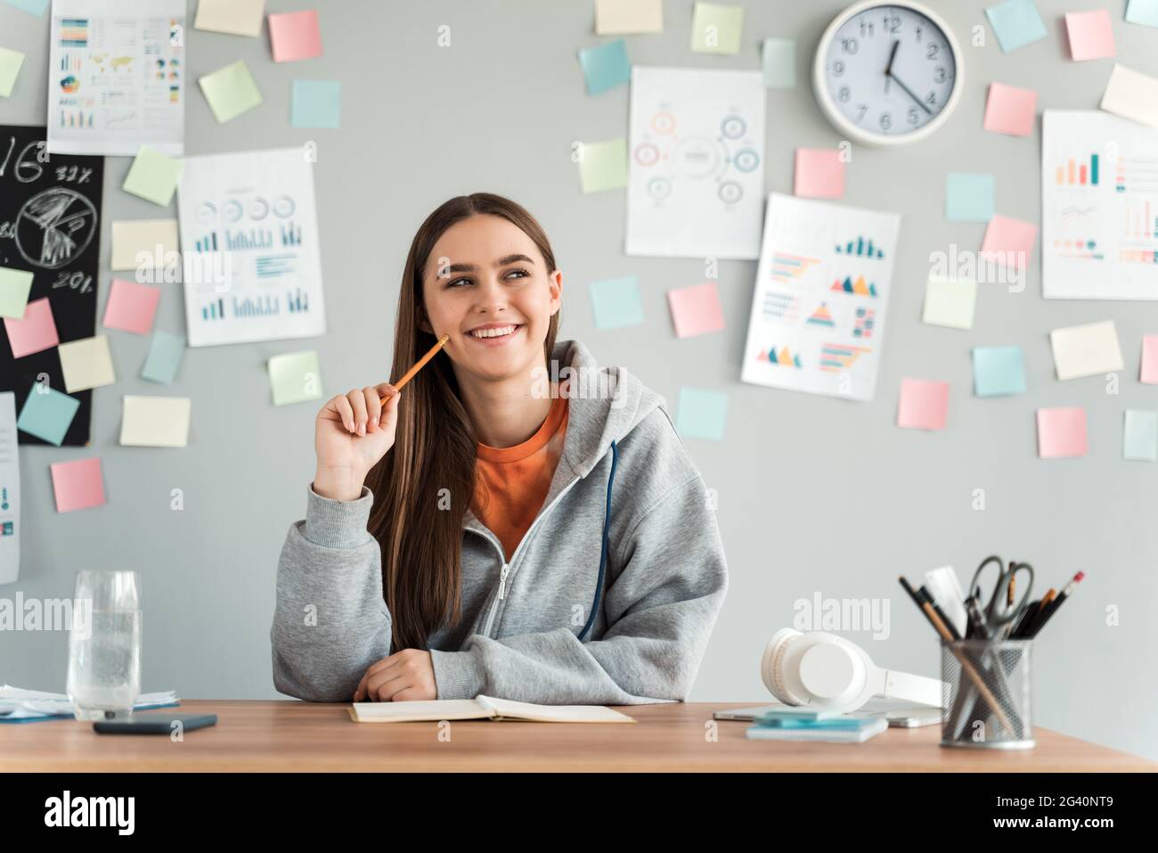 Portrait of a young student learning to take notes on a background of ...
