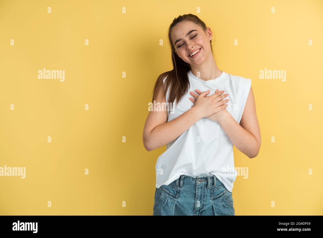 Portrait of positive girl putting hands on chest feel good wearing ...