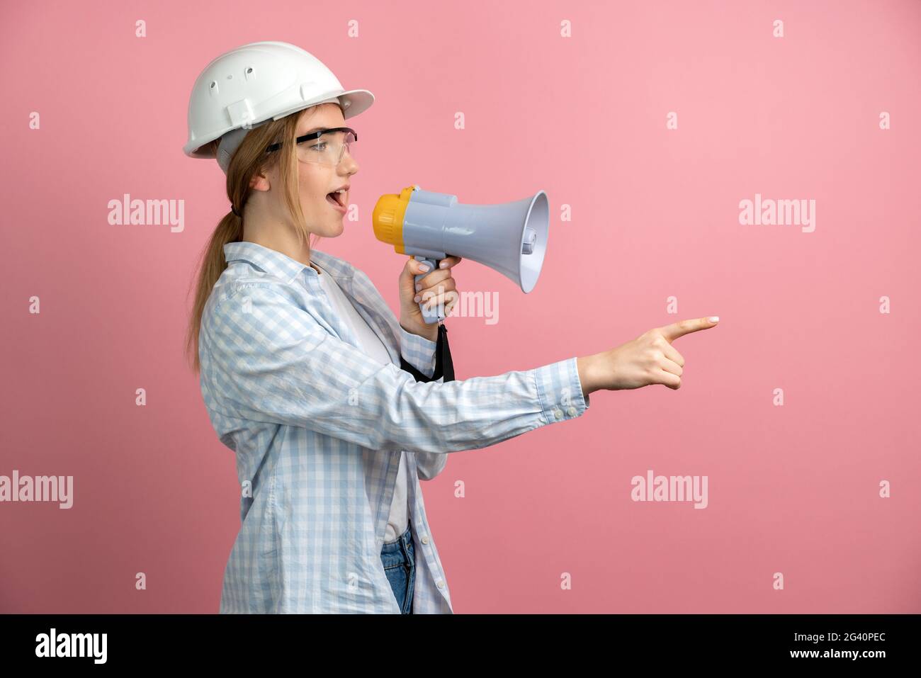 Young pretty woman over isolated pink background shouting through ...