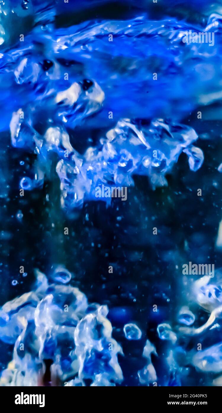 Vertical background of an empty fish tank with bubbles of blue water ...