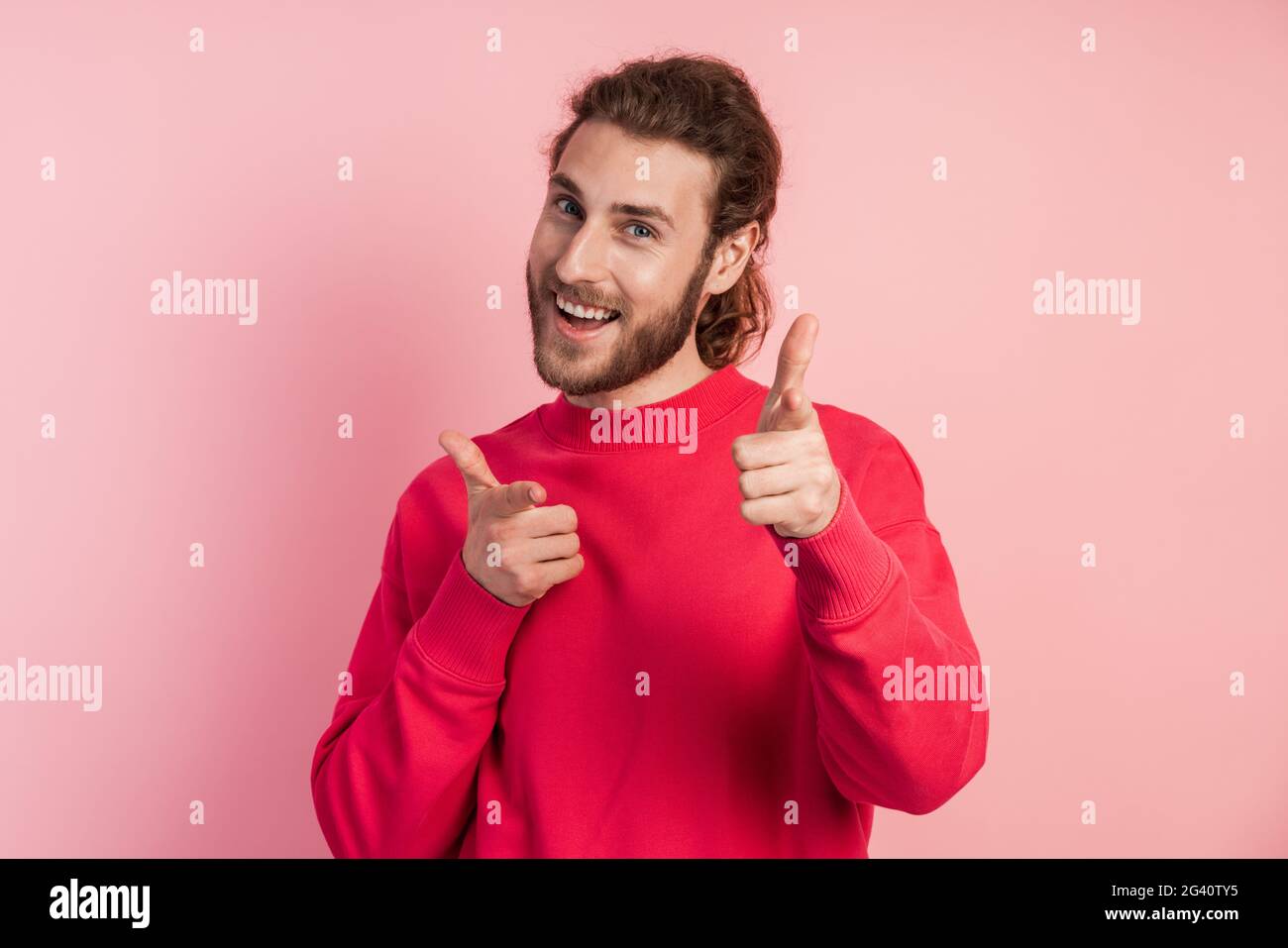 Cute, positive, smiling man shows a gun with his fingers. Humorous man ...