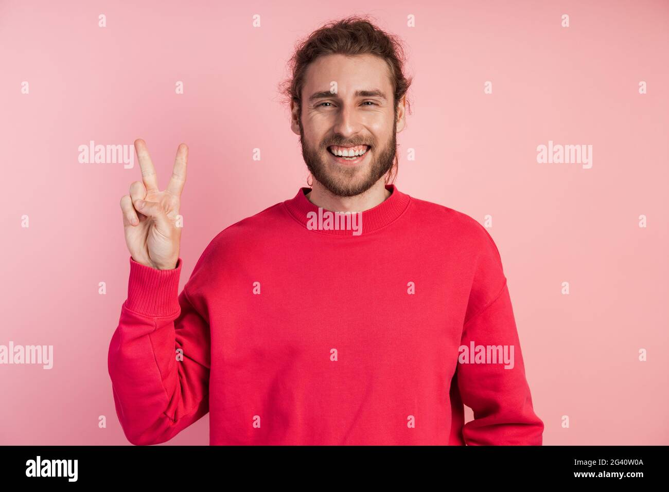 Guy shows the V sign, the sign of victory, peace. Positive young man on ...