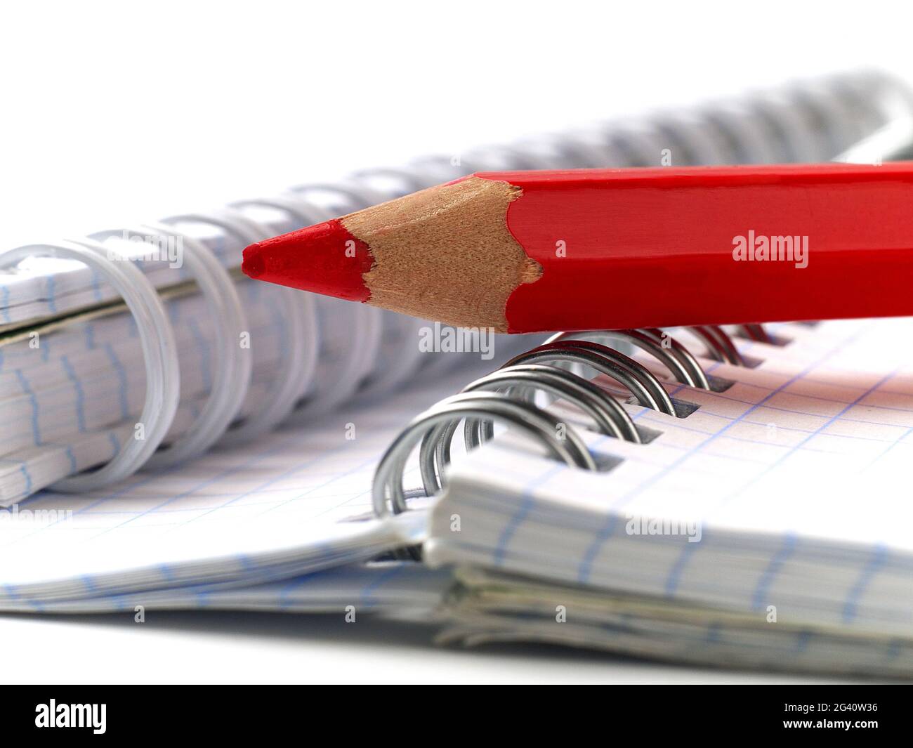 red pencil on spiral notebooks, macro Stock Photo - Alamy