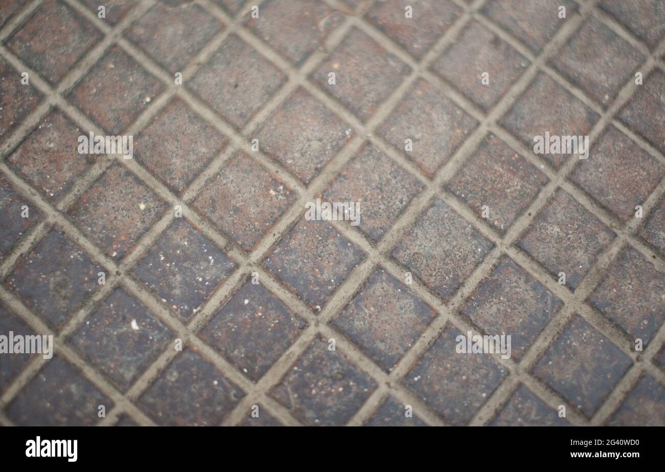Iron manhole cover with a true symmetrical checkered pattern as a ...