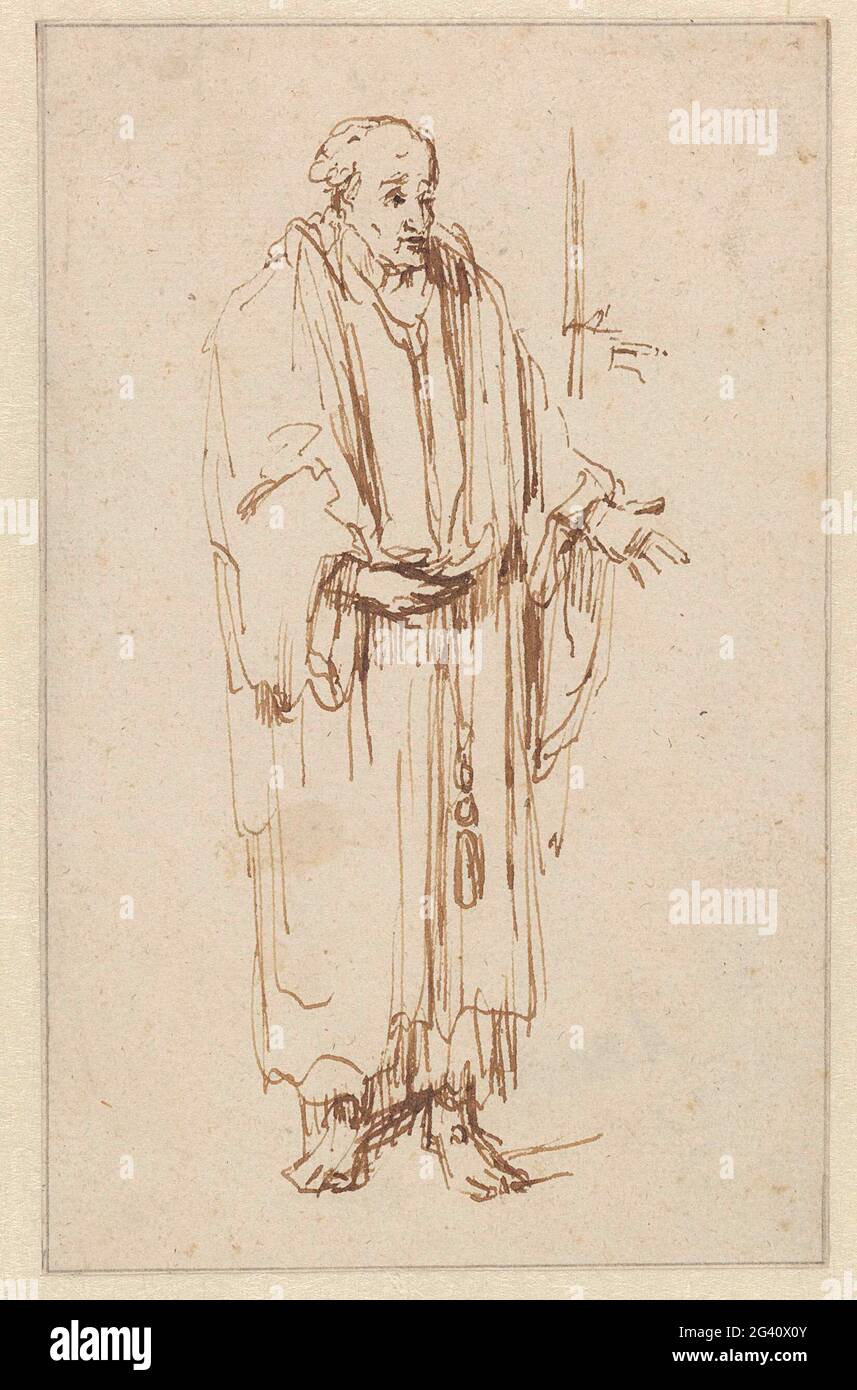 Standing man in long robe Stock Photo - Alamy