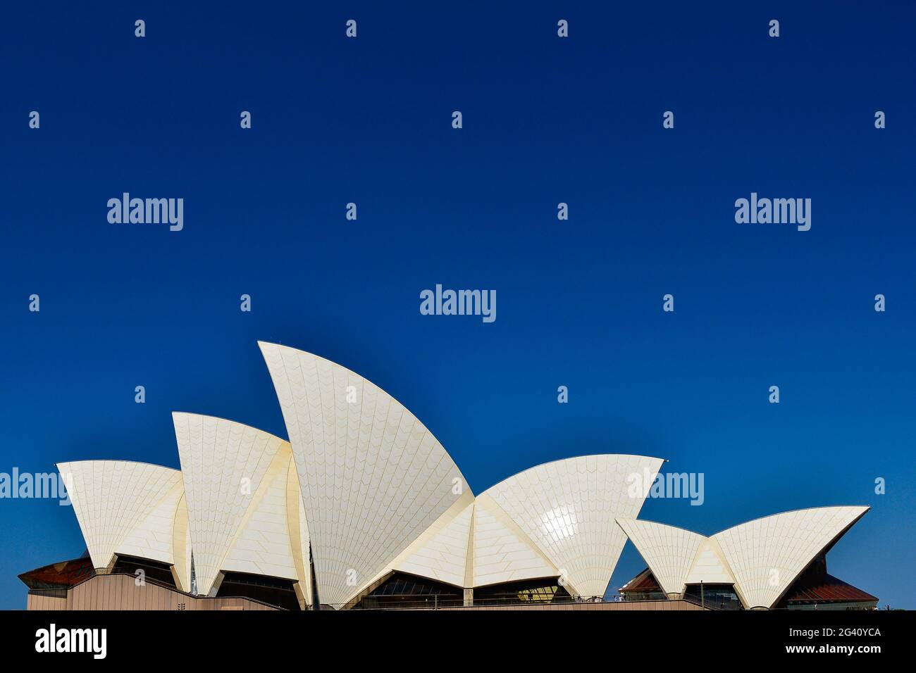 The Opera House glows in the sun against a deep blue sky, Sydney, New ...