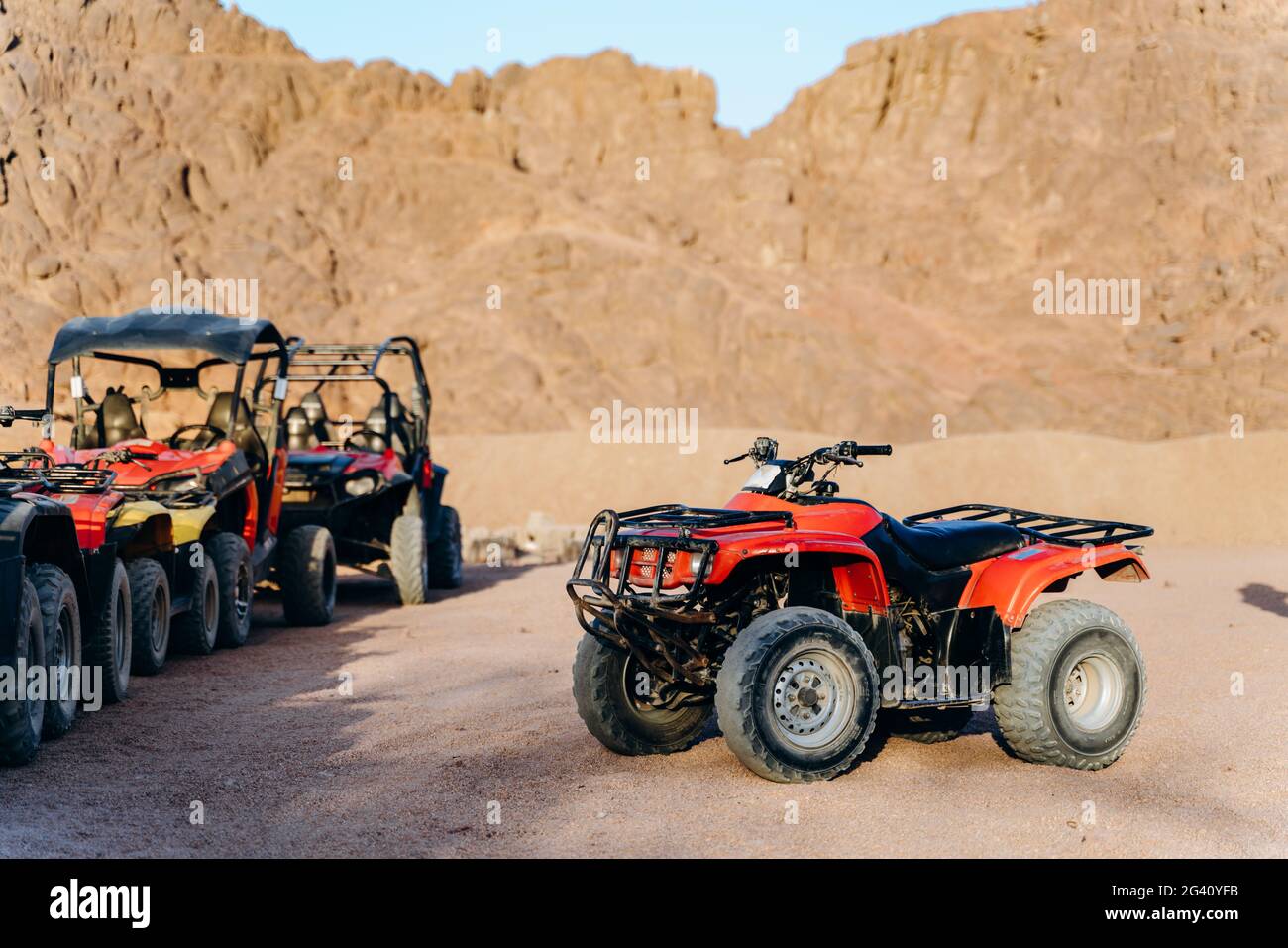 Group of ATVs and motorbikes lined up ready to go on a desert adventure ...