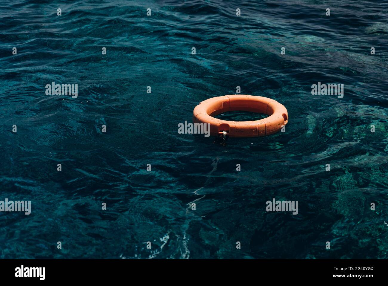 Orange lifebuoy in the blue sea. Lifebuoy - a way to escape Stock Photo ...