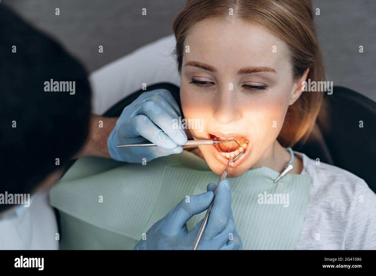 Close-up view, a doctor treats a person's teeth. The dentist examines ...