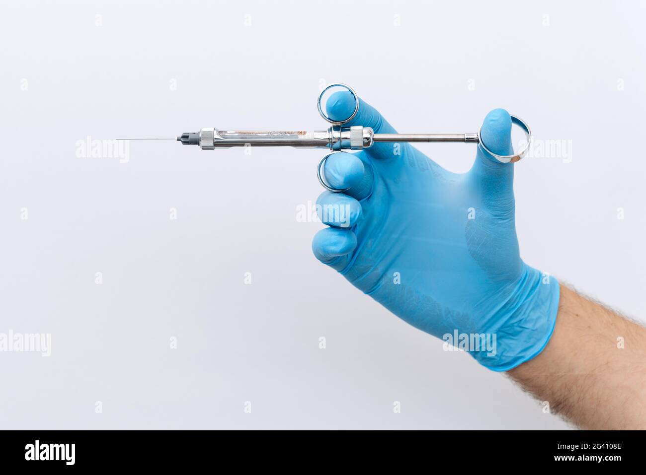 Anesthetist dentist doctor holds in his hand anesthesia syringe prior ...