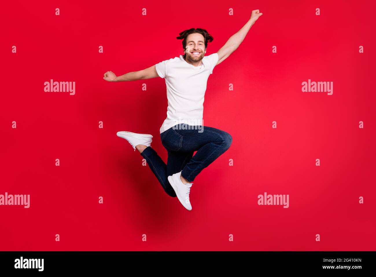 Full length photo of young man jump wear white t-shirt jeans isolated ...