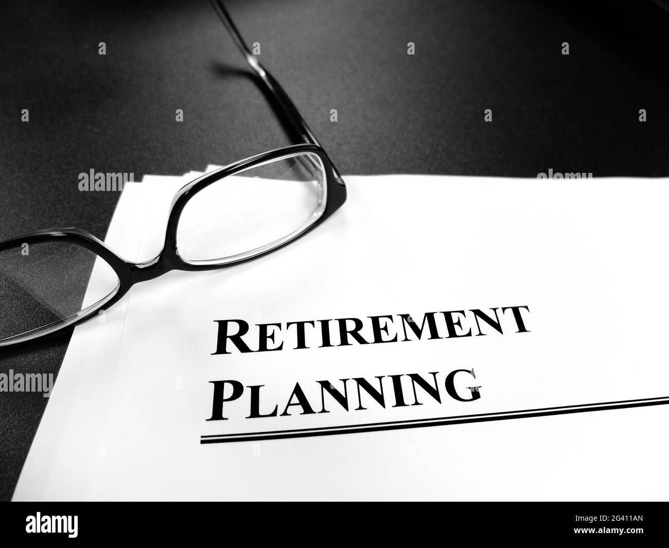Retirement planning documents on desk with glasses for plan to retire ...