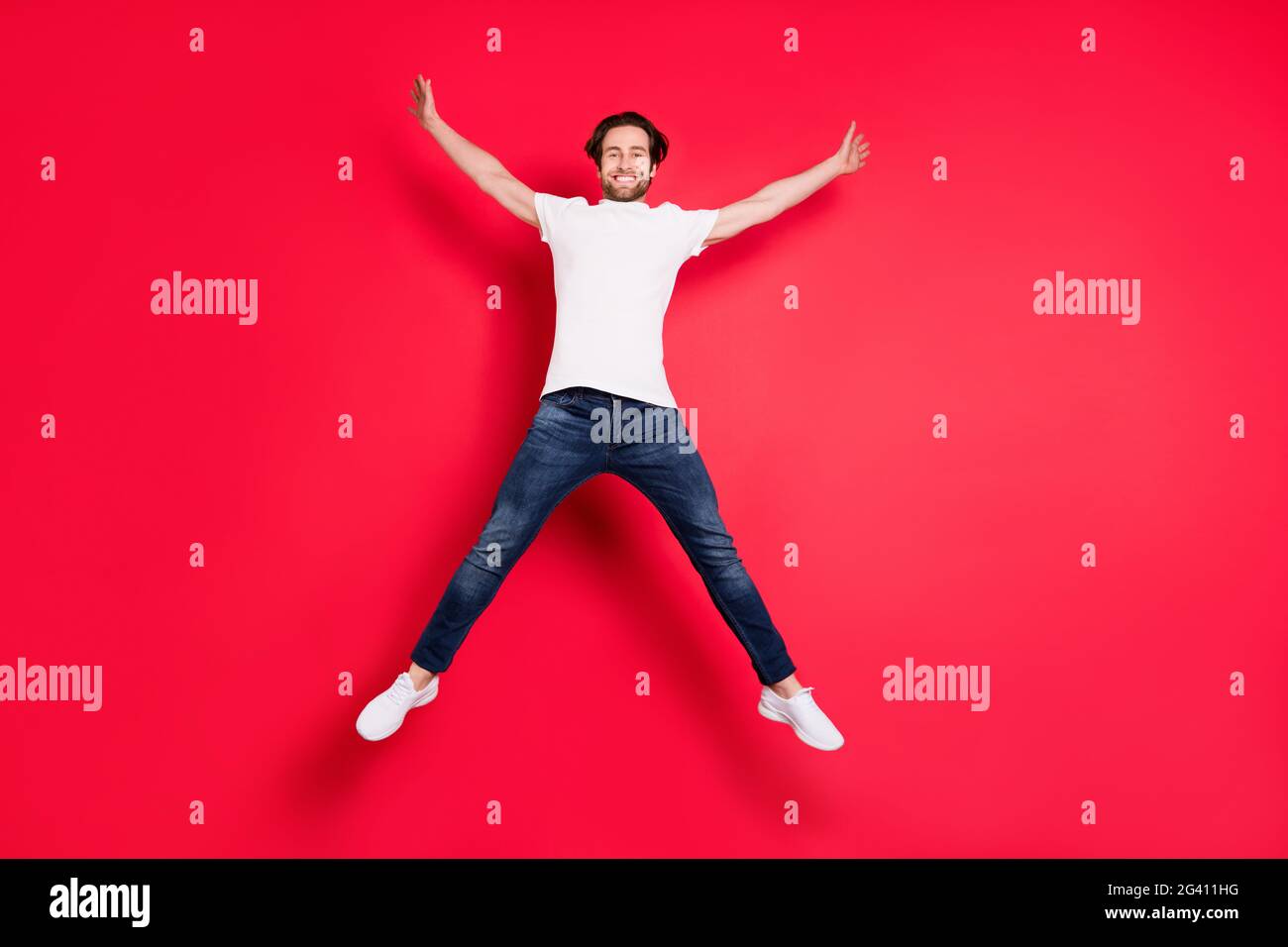 Full length photo of charming happy active young man jump up star shape ...