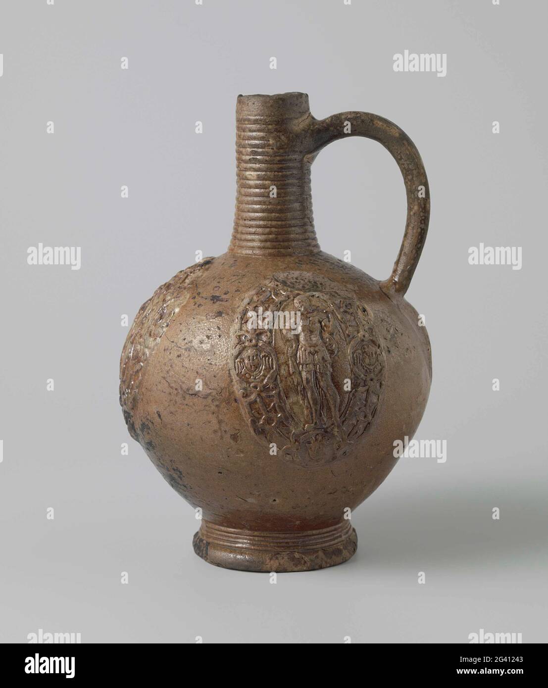 Jug. Brown jug with thin ribbed neck. On the spherical belly 3 large ...