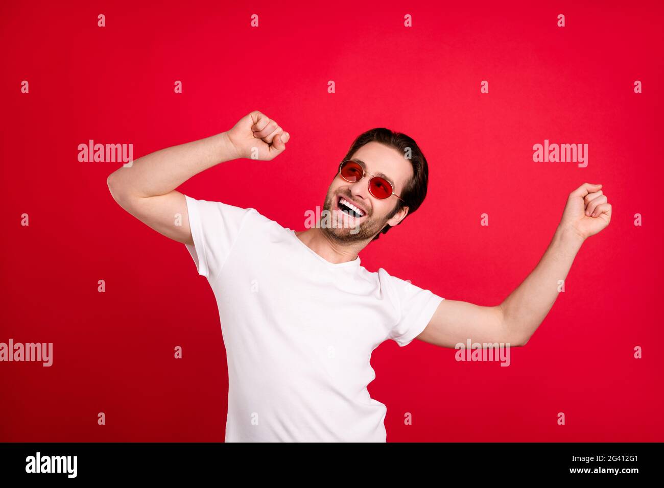 Photo of cool young brown hairdo man dance look empty space wear white ...