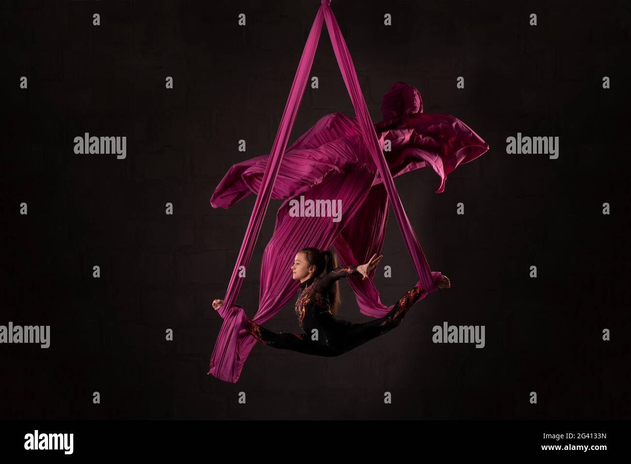 Woman performing acrobatic dance on aerial silks Stock Photo - Alamy