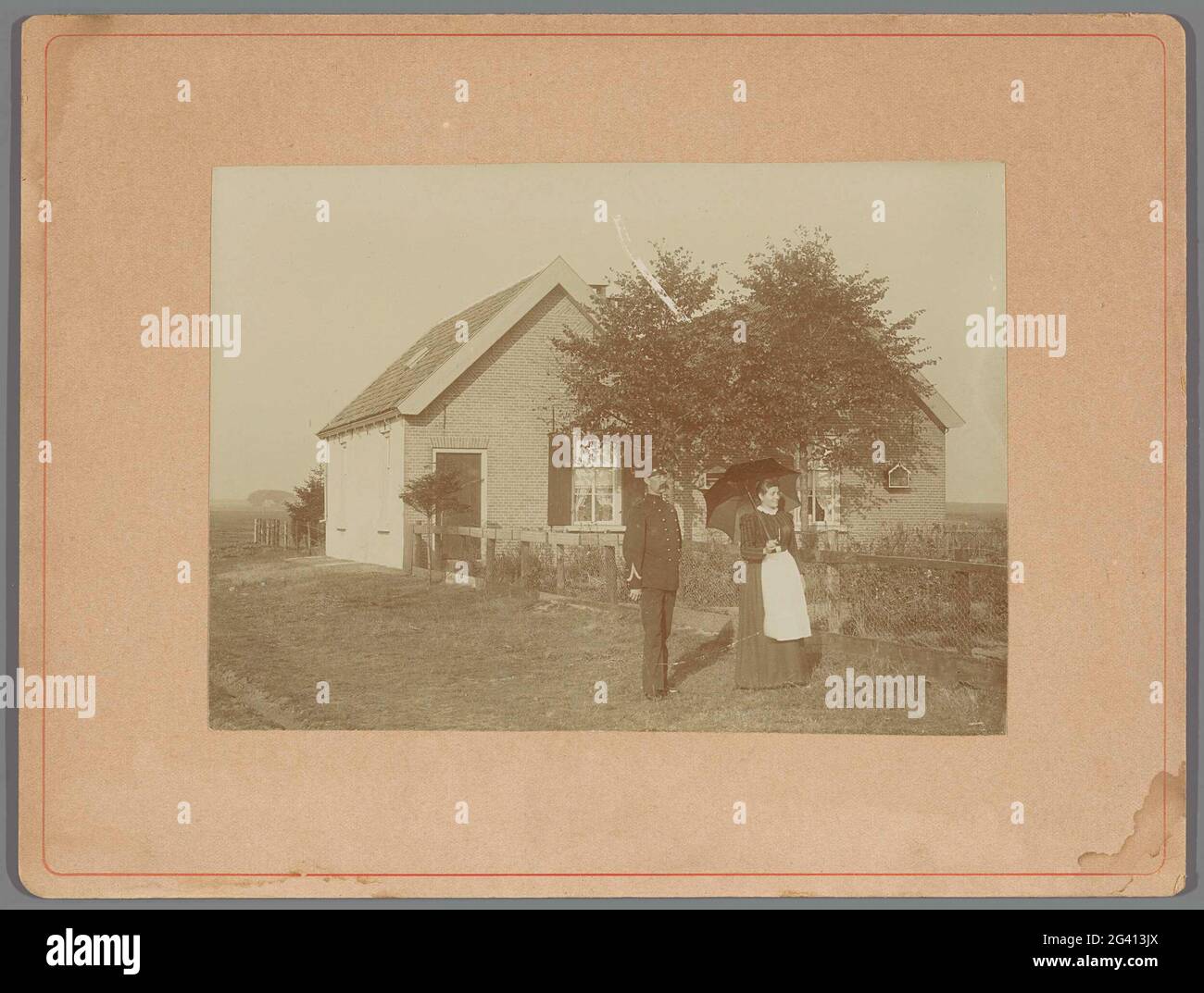 Portrait of police officer and woman with umbrella at their house Stock ...
