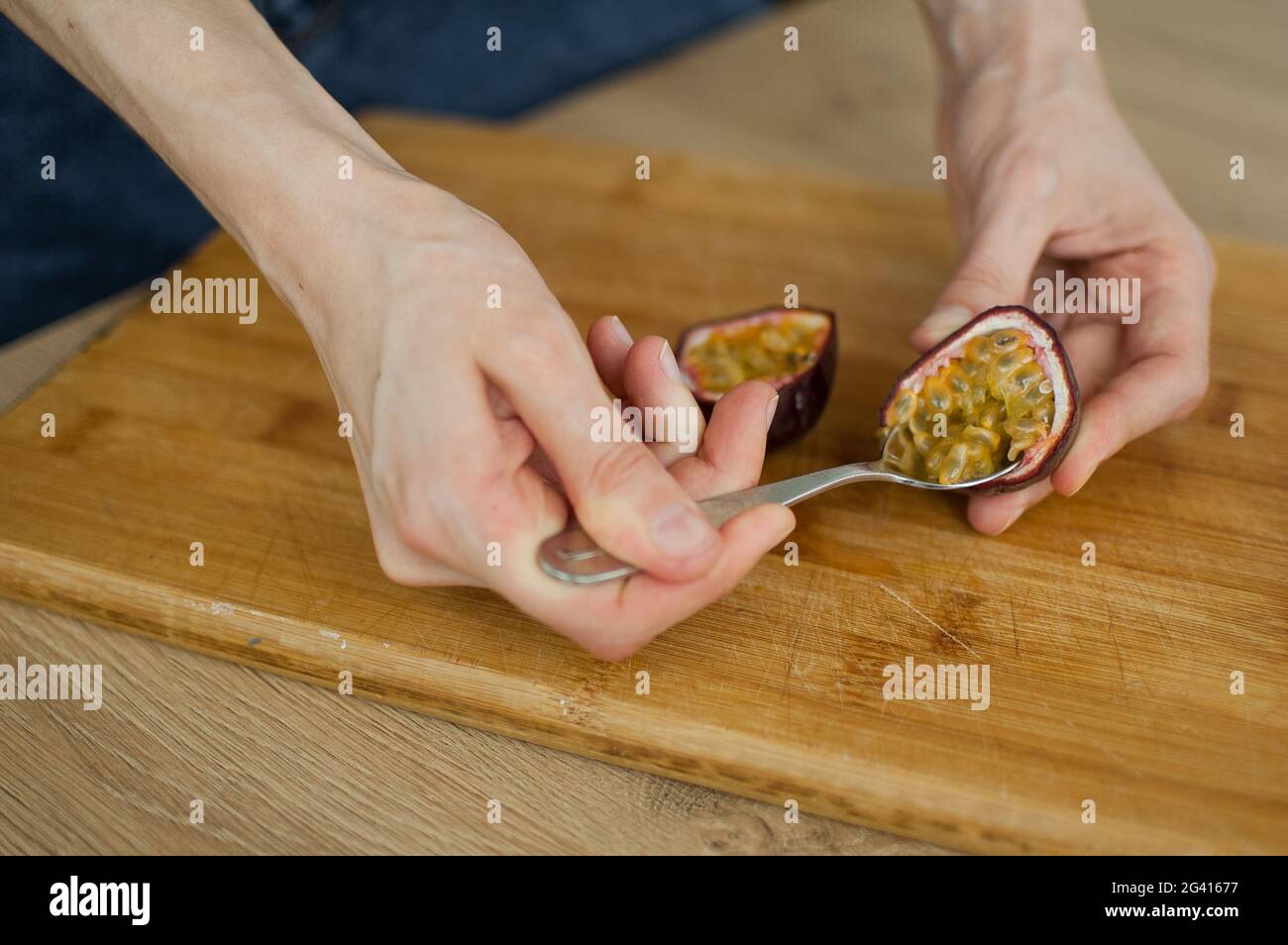 Female eats fresh organic ripe granadilla or yellow passion fruit with ...