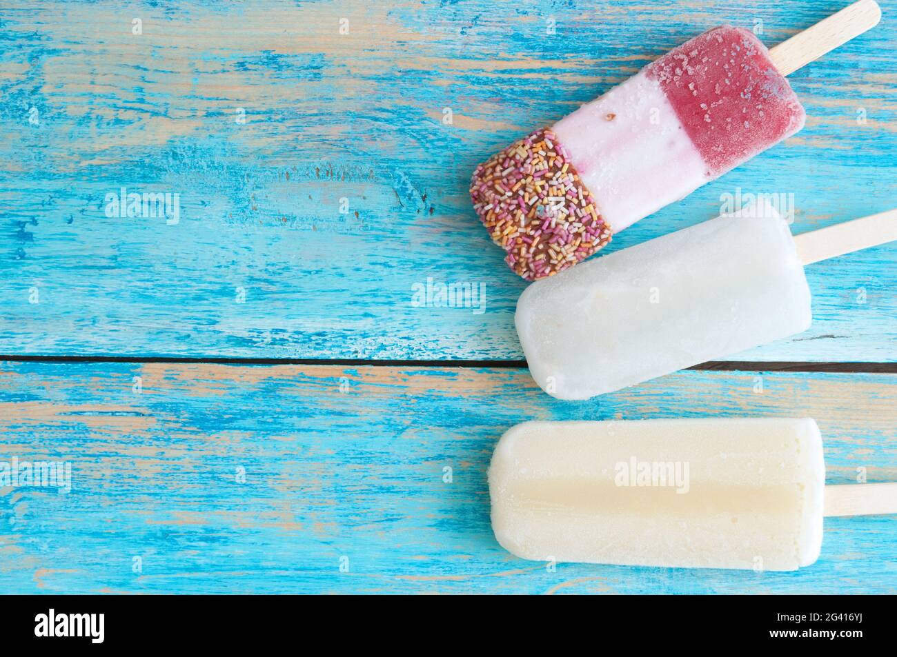 Frozen assorted ice lollies on a wooden background Stock Photo - Alamy