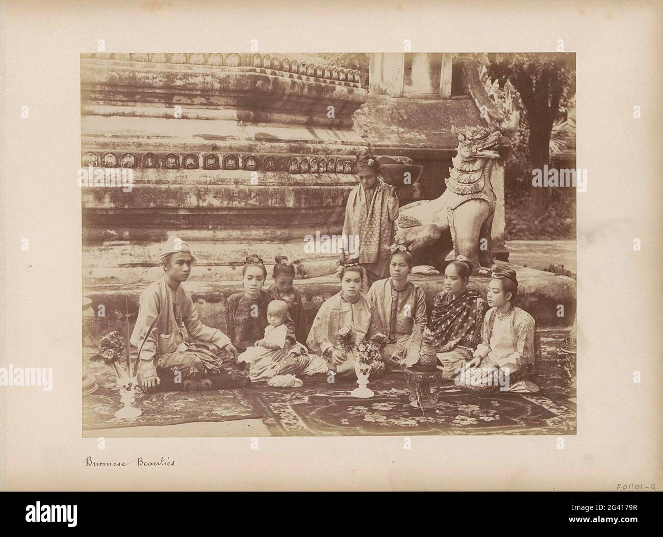 Portrait of a group of young Burmese women, children and a man sitting ...