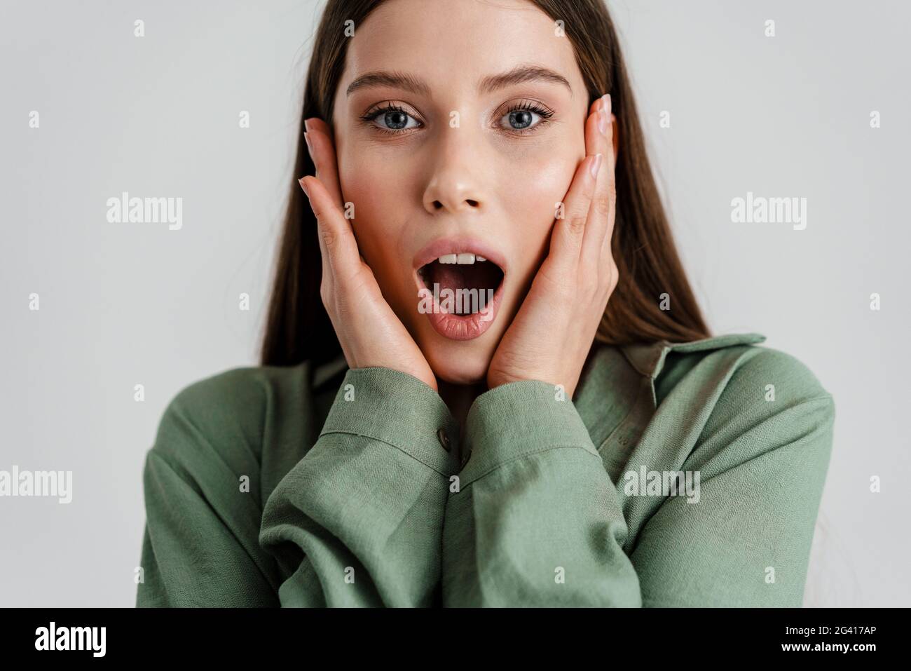 Excited caucasian girl expressing surprise at camera isolated over ...