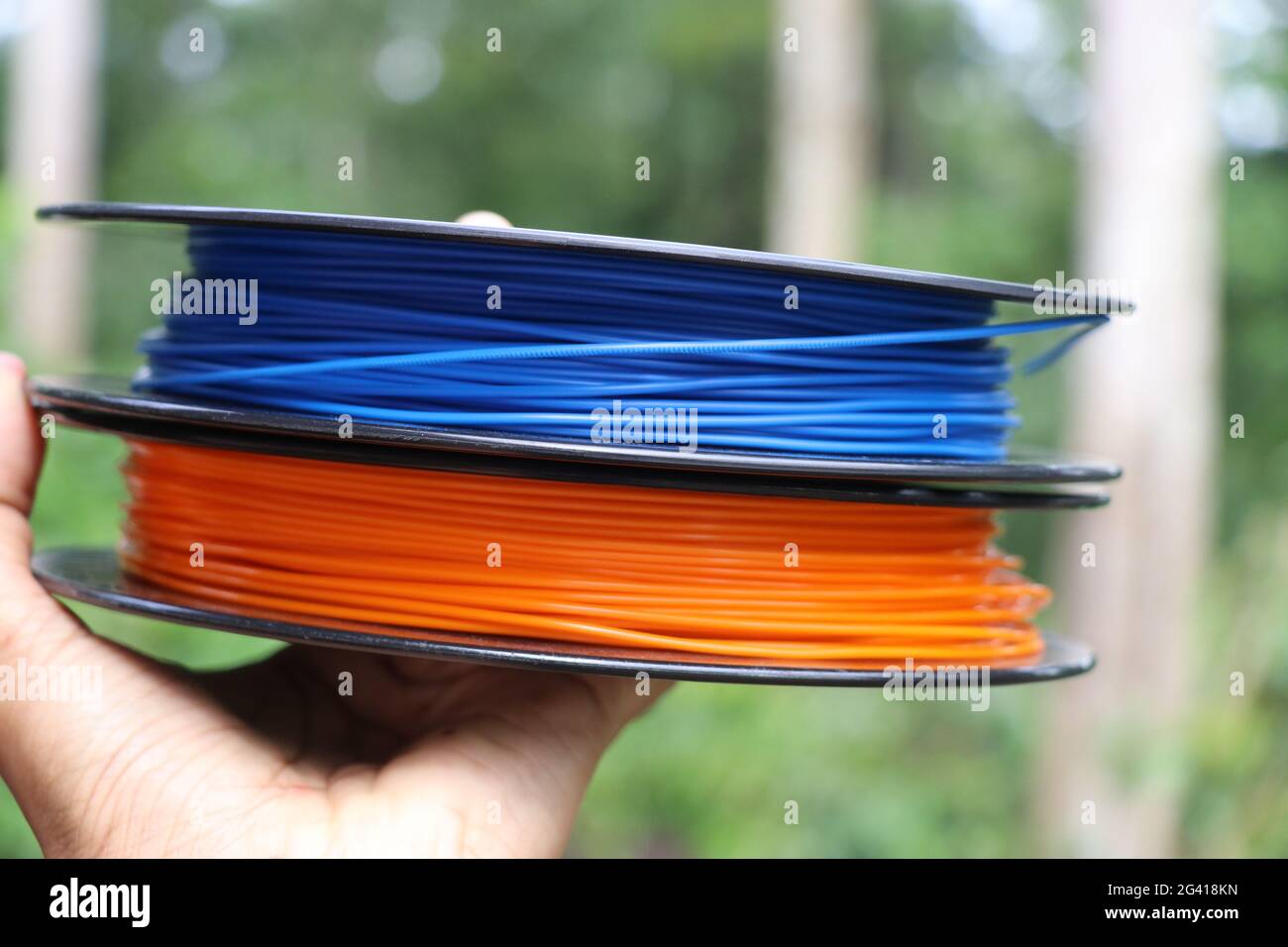 3D Printer filament on nature background with concept to show filament ...