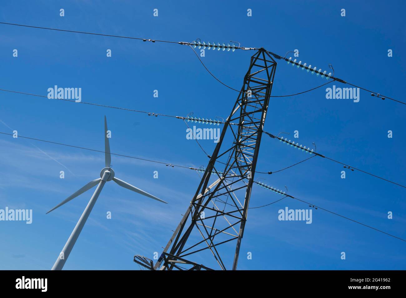 Wind turbine and electricity pylons in Powys,Wales,UK Stock Photo - Alamy
