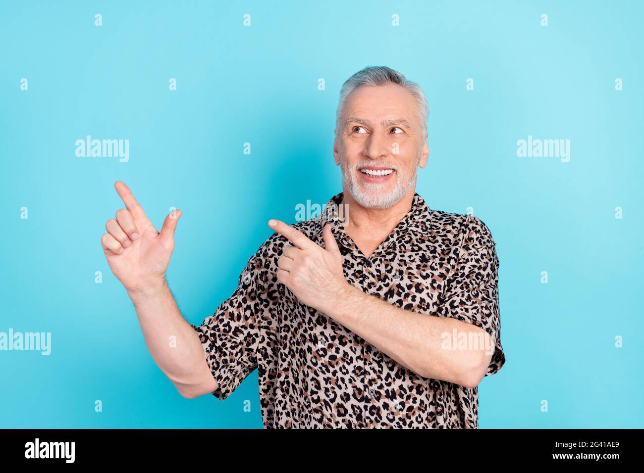 Photo of cheerful charming old man look point finger empty space sale ...