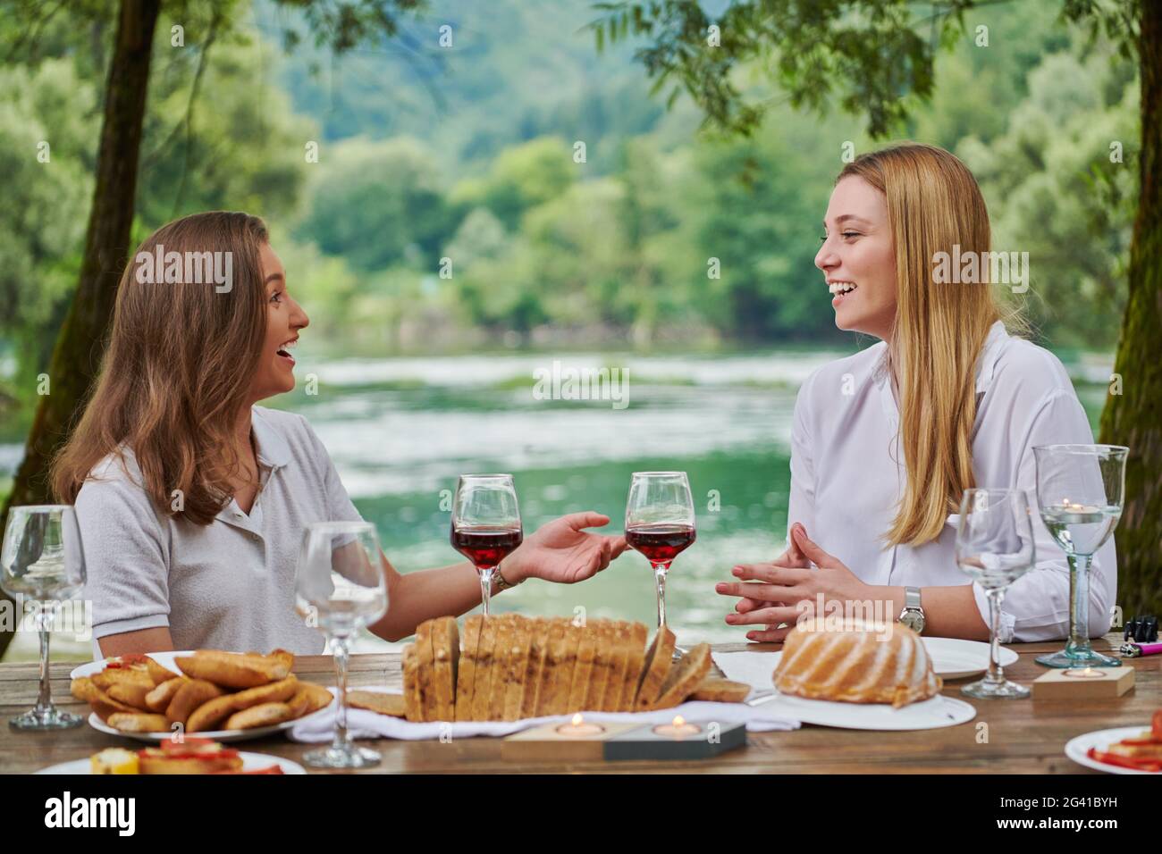 Girlfriends having picnic french dinner party outdoor Stock Photo - Alamy