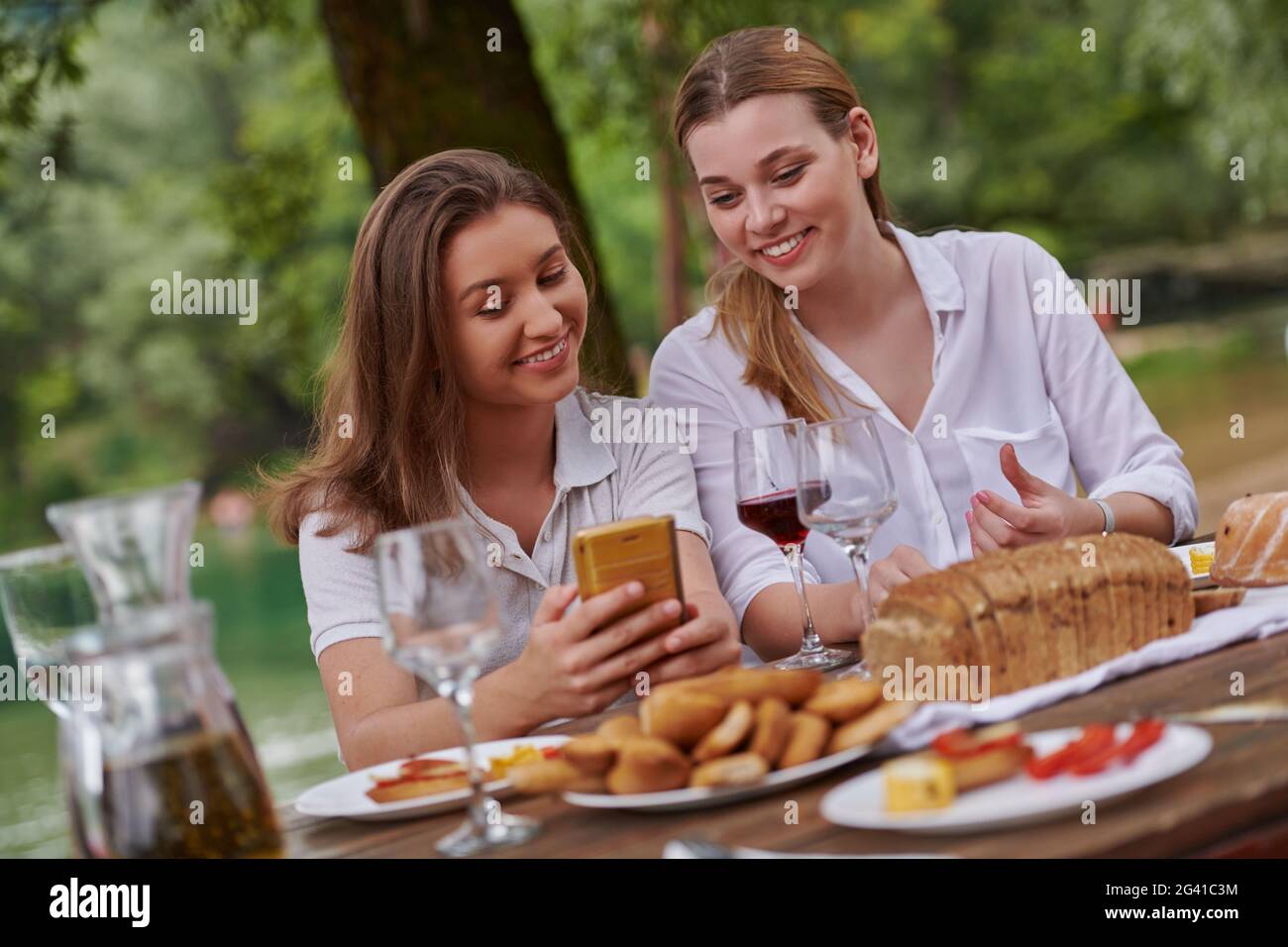 Girlfriends having picnic french dinner party outdoor Stock Photo - Alamy