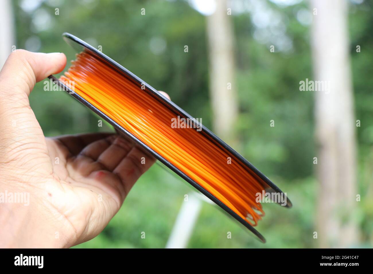 3D printing material made from bio plastic. PLA filament orange spool ...