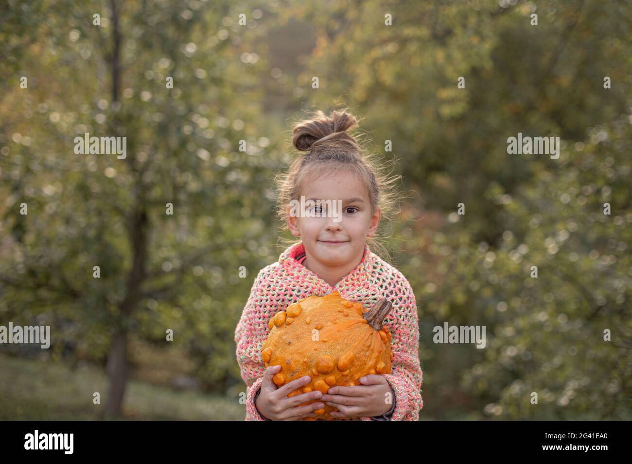 Deformed ugly orange pumpkin in a child hands Stock Photo - Alamy