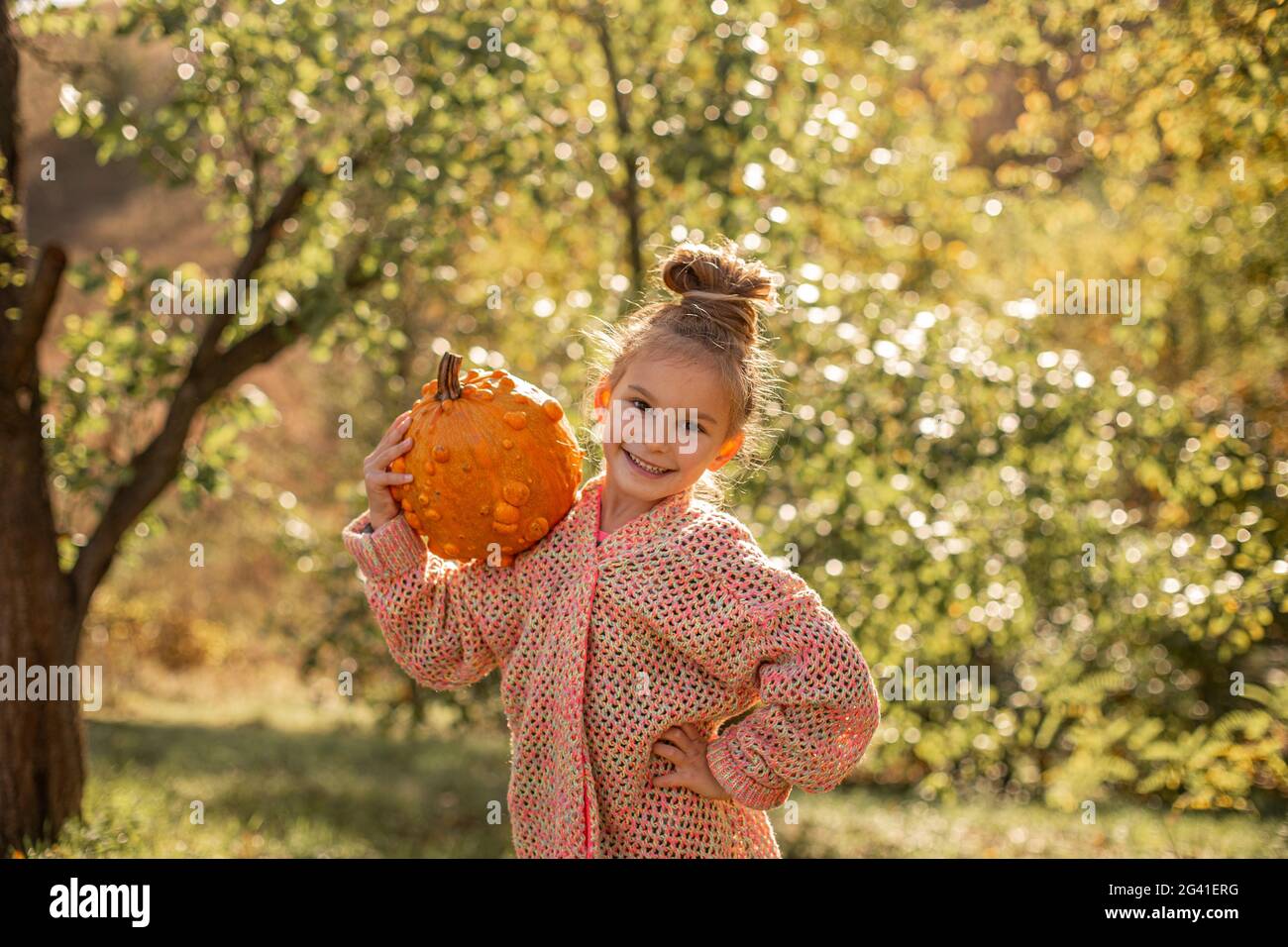 Deformed ugly orange pumpkin in a child hands Stock Photo - Alamy