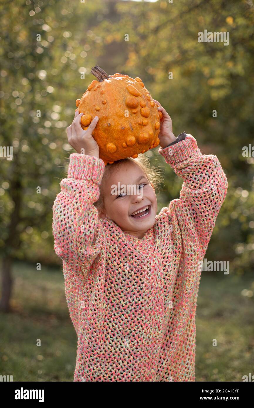 Deformed ugly orange pumpkin in a child hands Stock Photo - Alamy