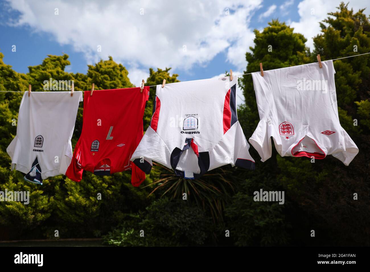 Collection of England shirts are seen hanging on a washing line ahead ...