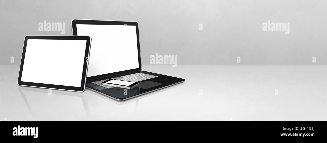 Laptop, mobile phone and digital tablet pc on white concrete office ...