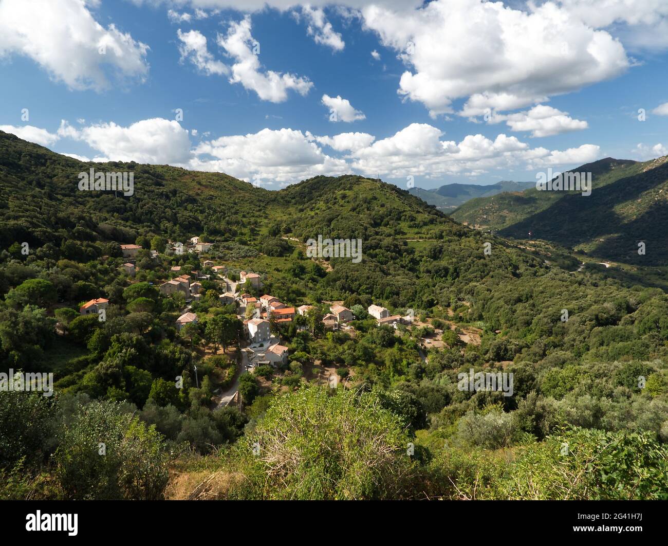 Landscape with a tiny village in the middle of the mountains under the ...