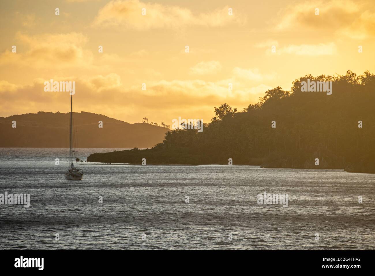 Silhouette of sailboat and island at sunrise, Sawa-i-Lau Island, Yasawa ...