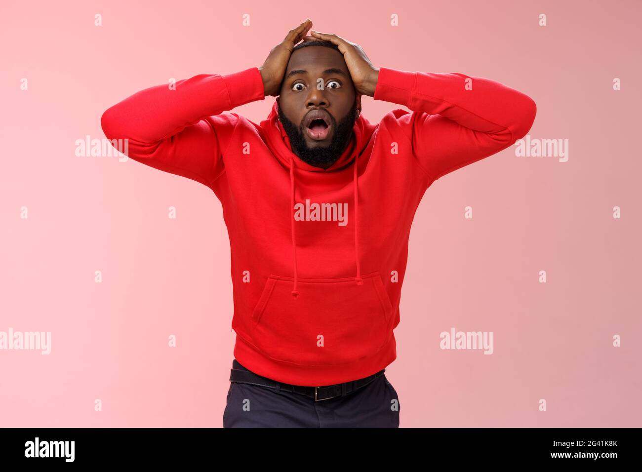 Impressed concerned black guy standing stupor worried grab head shocked ...