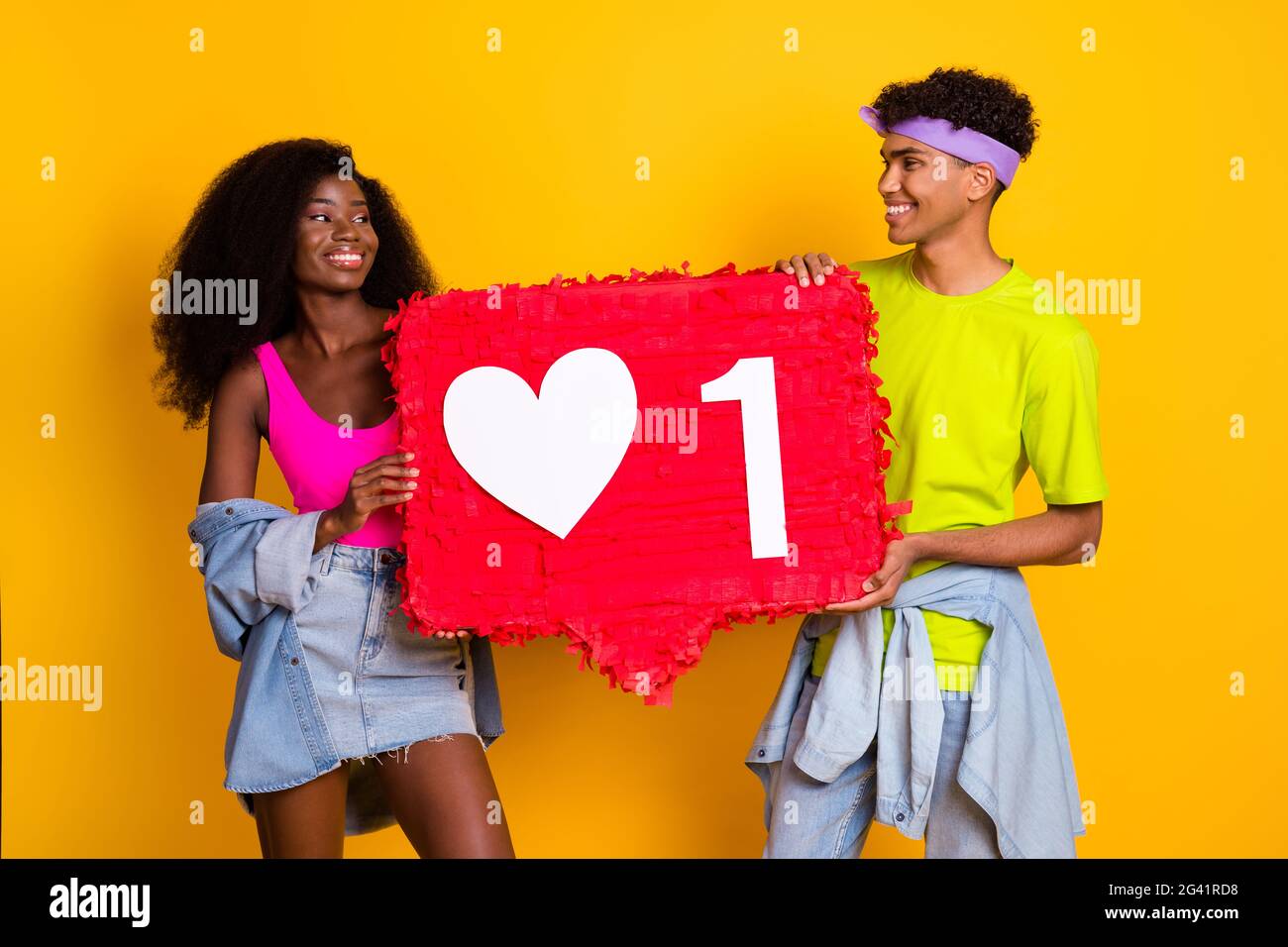 Photo of charming cute young people wear jeans clothes holding big ...