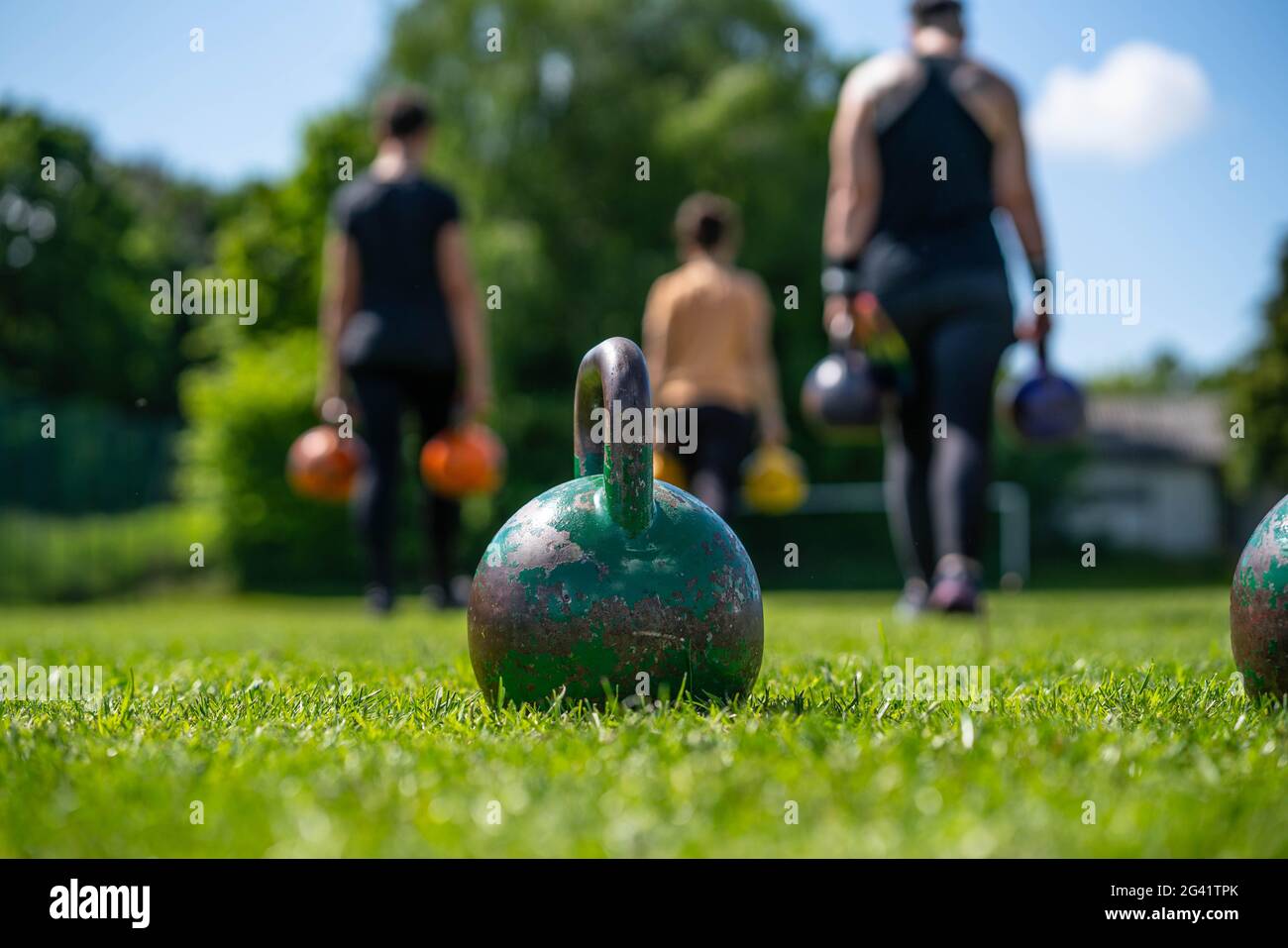 kettlebells in green grass - fitness concept outdoors Stock Photo - Alamy