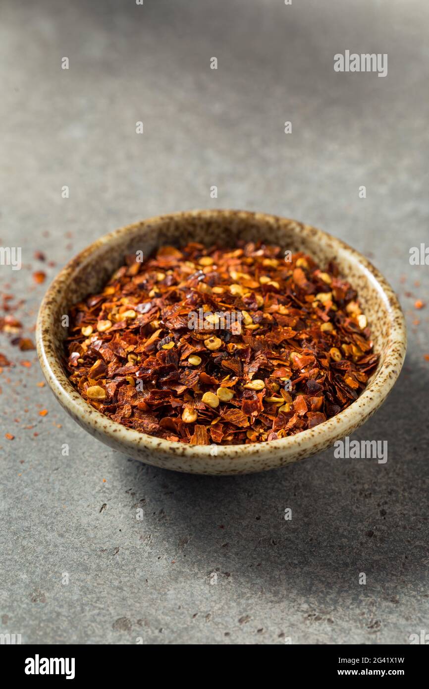 Organic Raw Red Pepper Flakes in a Bowl Stock Photo - Alamy