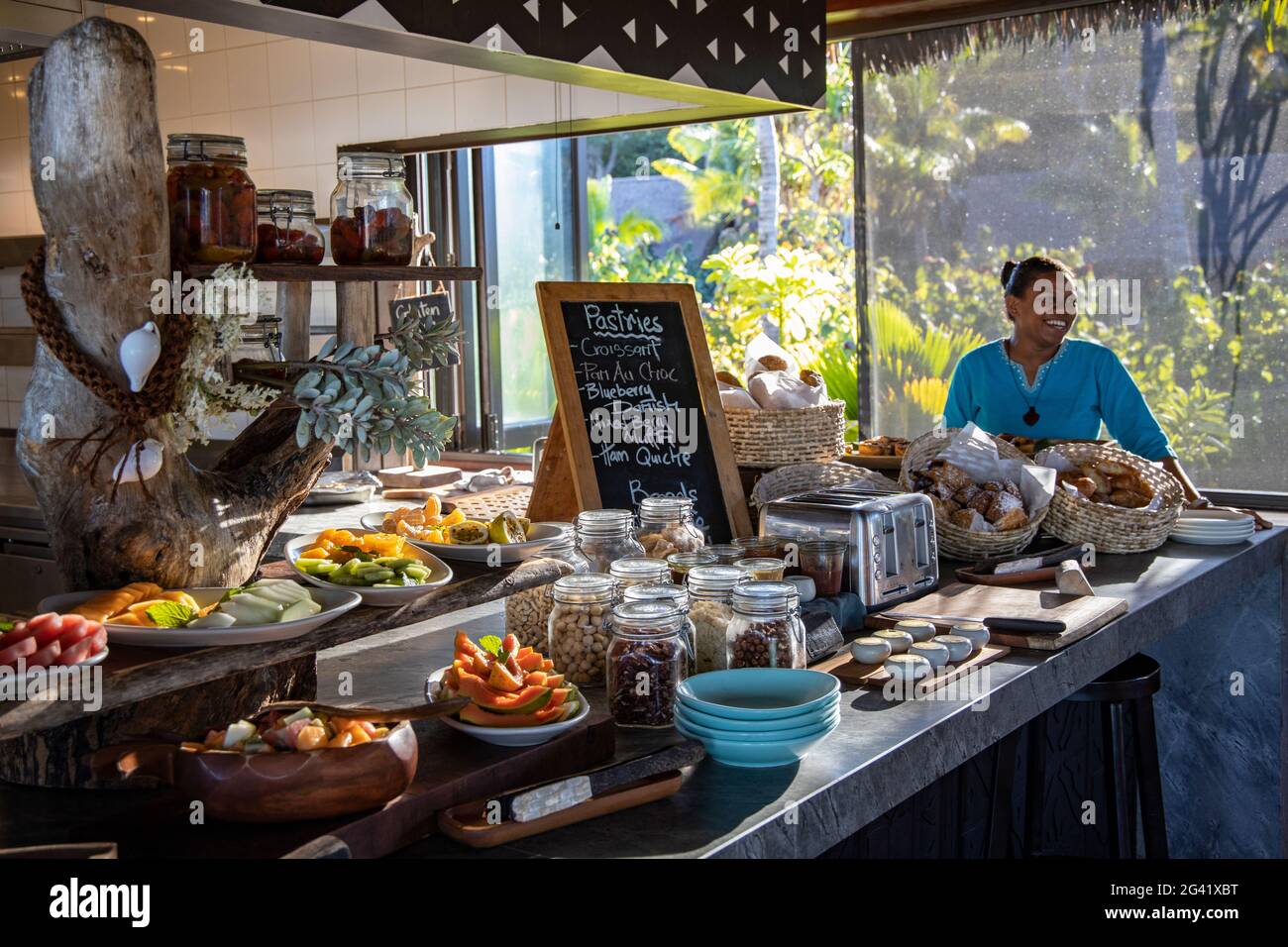 Smiling waitress behind a fantastic breakfast buffet in the Tovolea ...