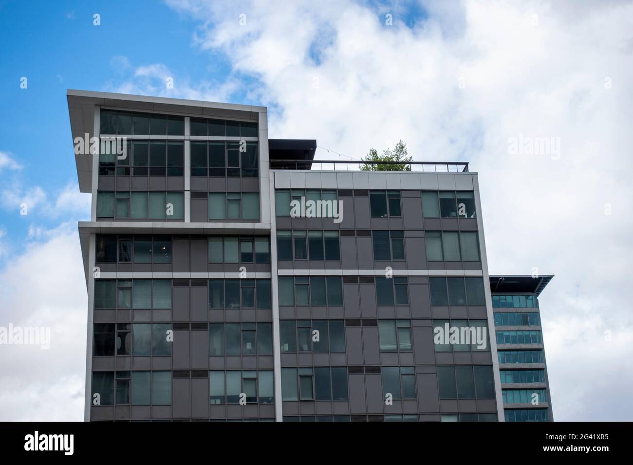Front view of a nameless apartment building in a downtown area against ...