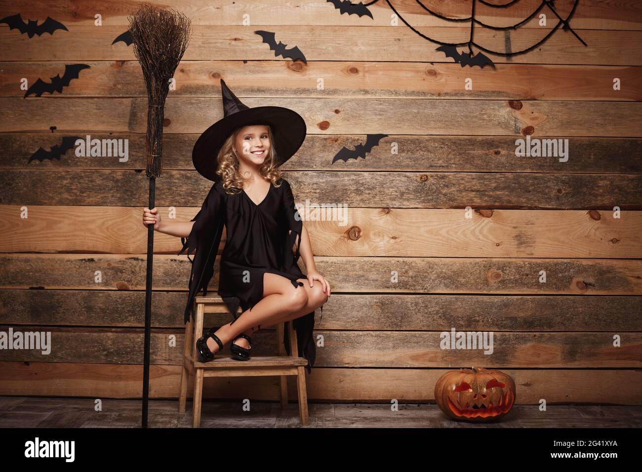 Halloween Witch concept - Full-length shot of little caucasian witch ...
