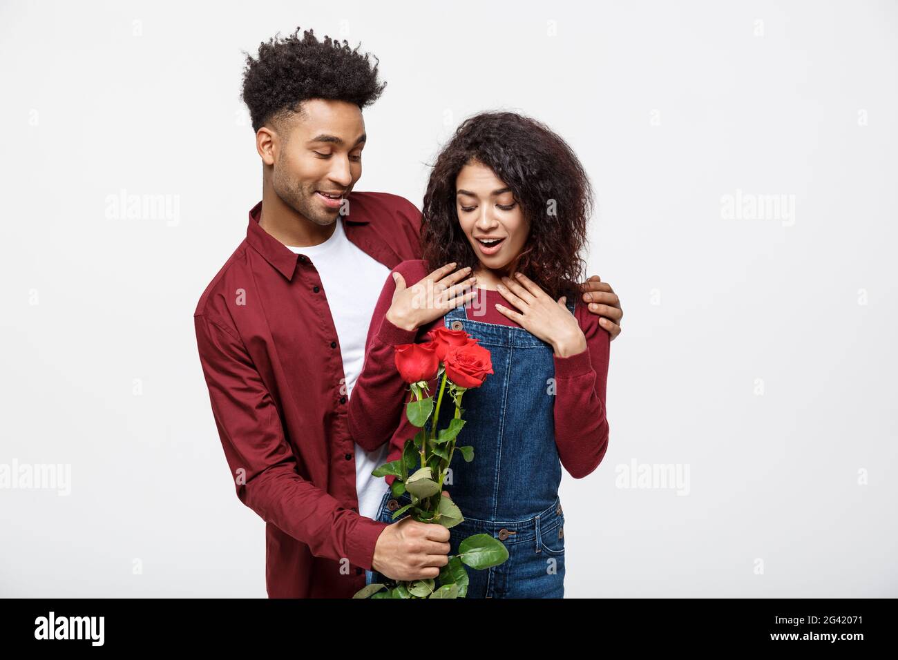Beautiful elegant couple is hugging and smiling, on gray background ...