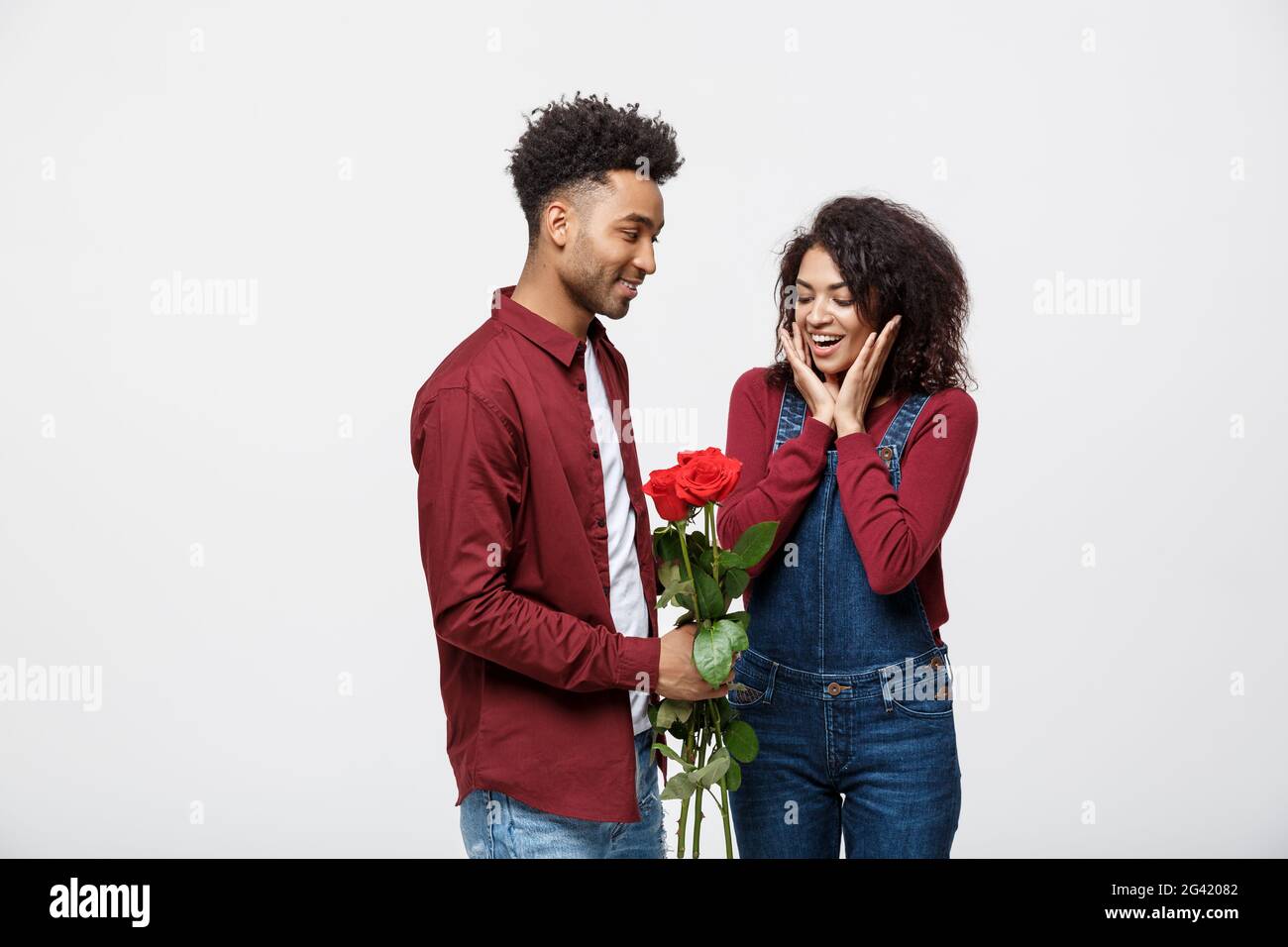 Beautiful elegant couple is hugging and smiling, on gray background ...